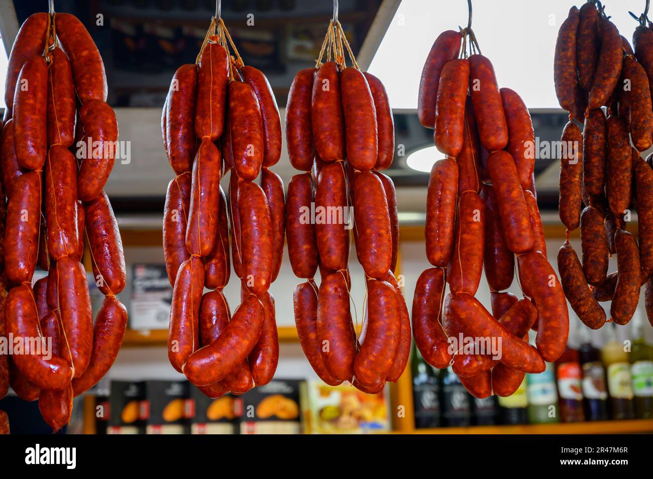 Spanish pork sausages chorizo hanging on butchers shop on farmers ...
