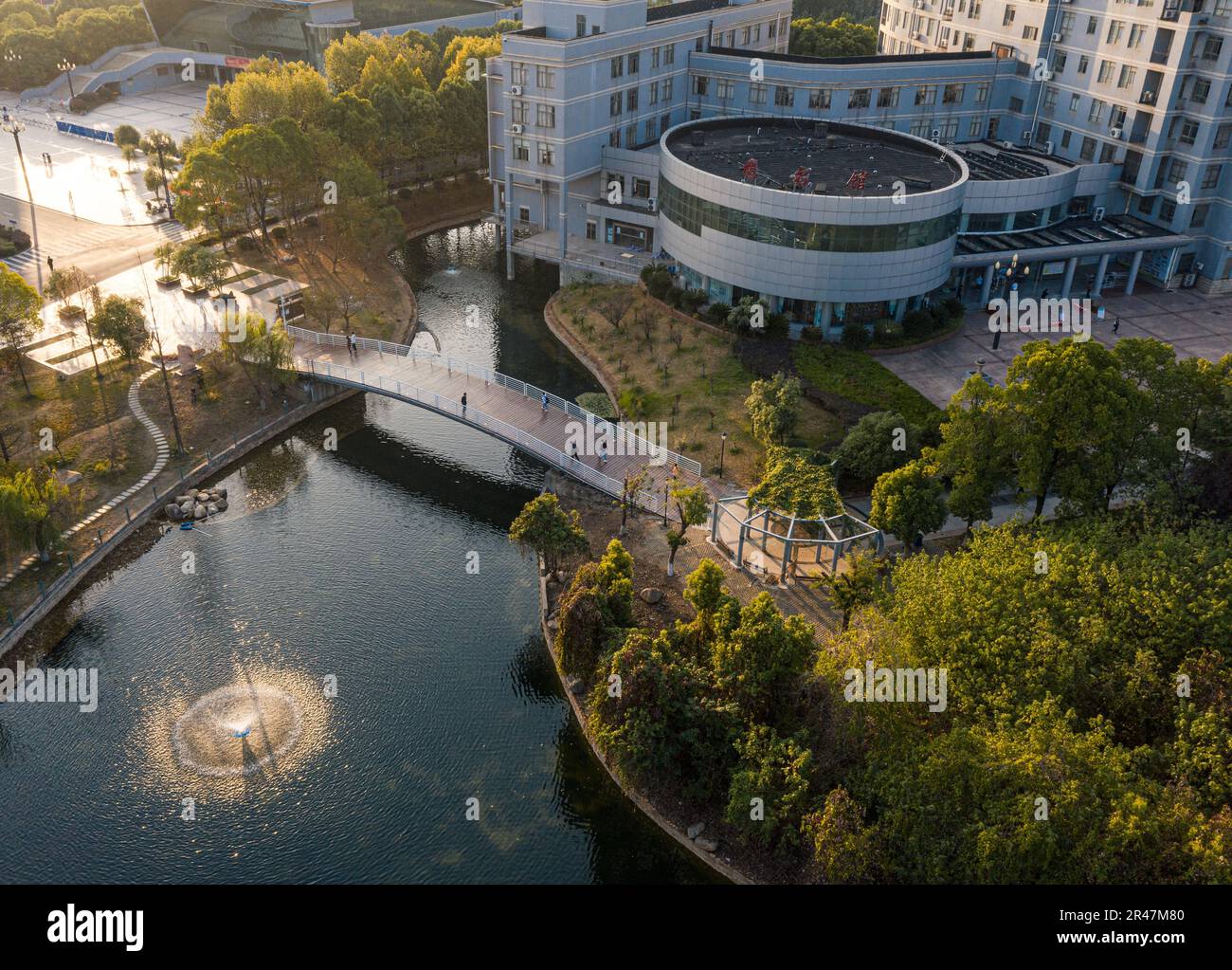 An aerial view of a modern cityscape featuring a tall building ...