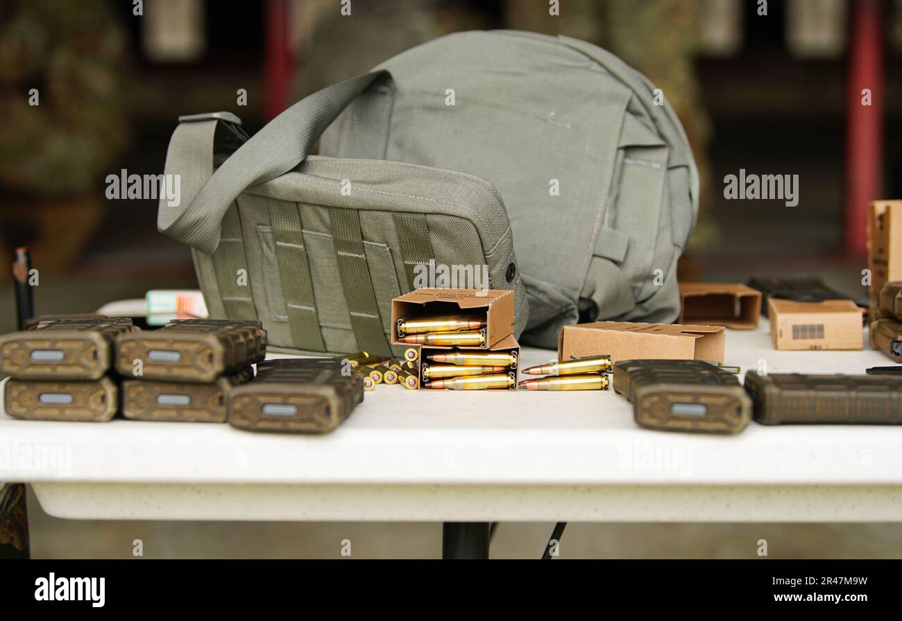 Bullets, magazines and tactical gear line a table as U.S. Airmen ...