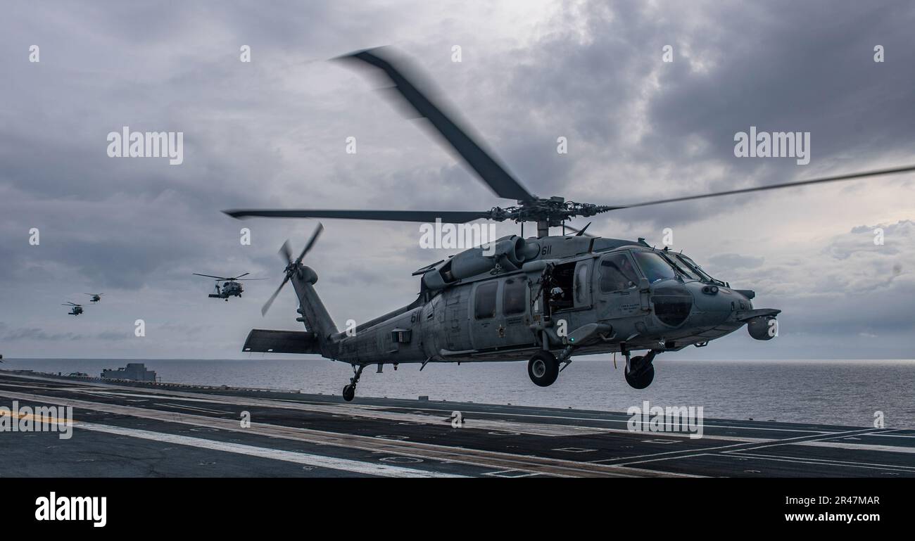 230212-N-DU622-1307 SOUTH CHINA SEA (Feb.12, 2023) An MH-60S Sea Hawk ...