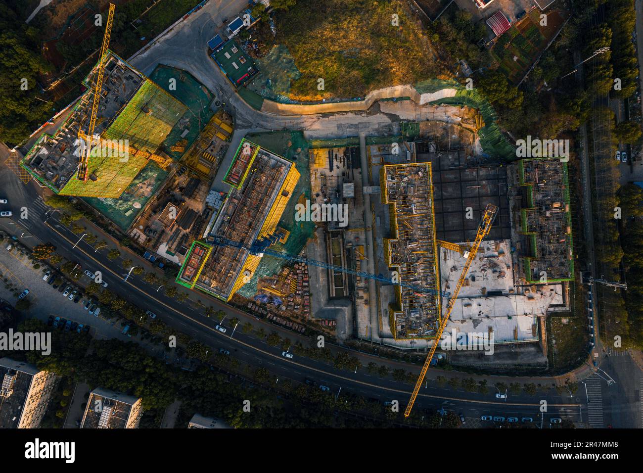 Aerial view of a bustling construction site, with workers, heavy ...