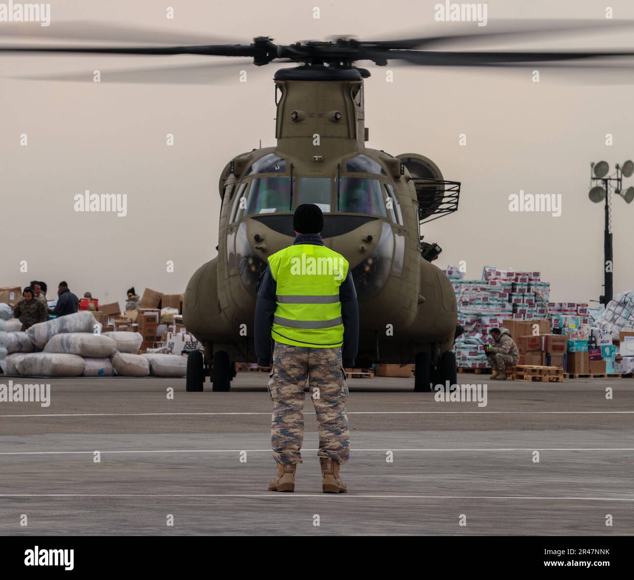 A Turkish military personnel guides a CH-47 Chinook helicopter on the ...