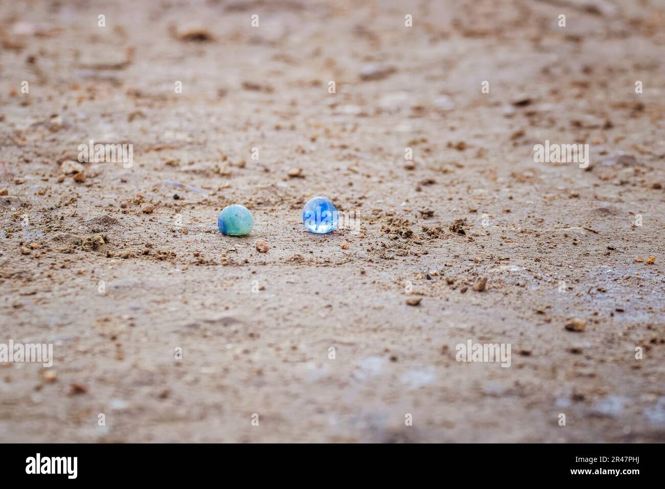 A high-resolution photograph of two white and grey marble balls resting ...