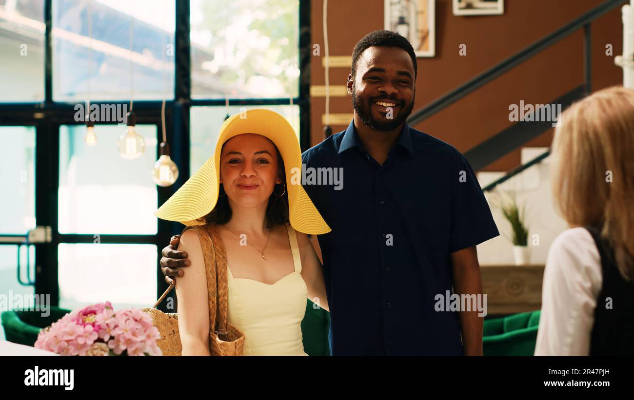 Guests waiting to do check in Stock Photo - Alamy