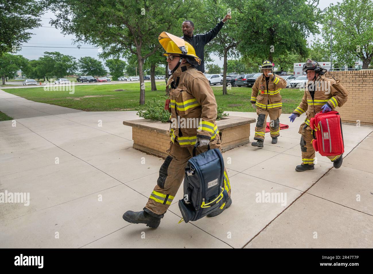 U.S. Air Force firefighters, 902nd Civil Engineer Squadron, enter a ...