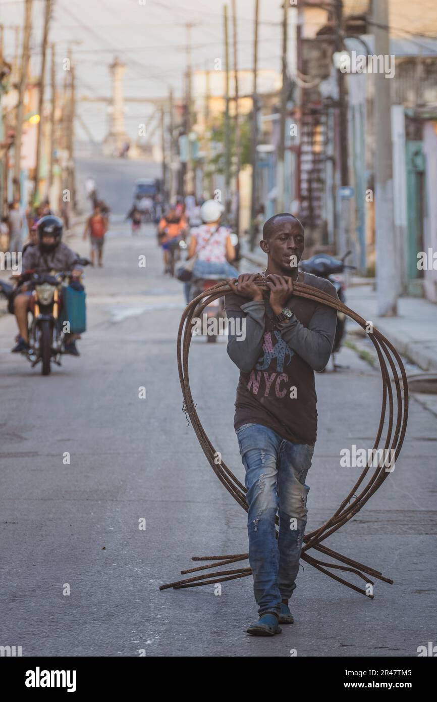 An African-American man dragging multiple steel bars in the streets of ...