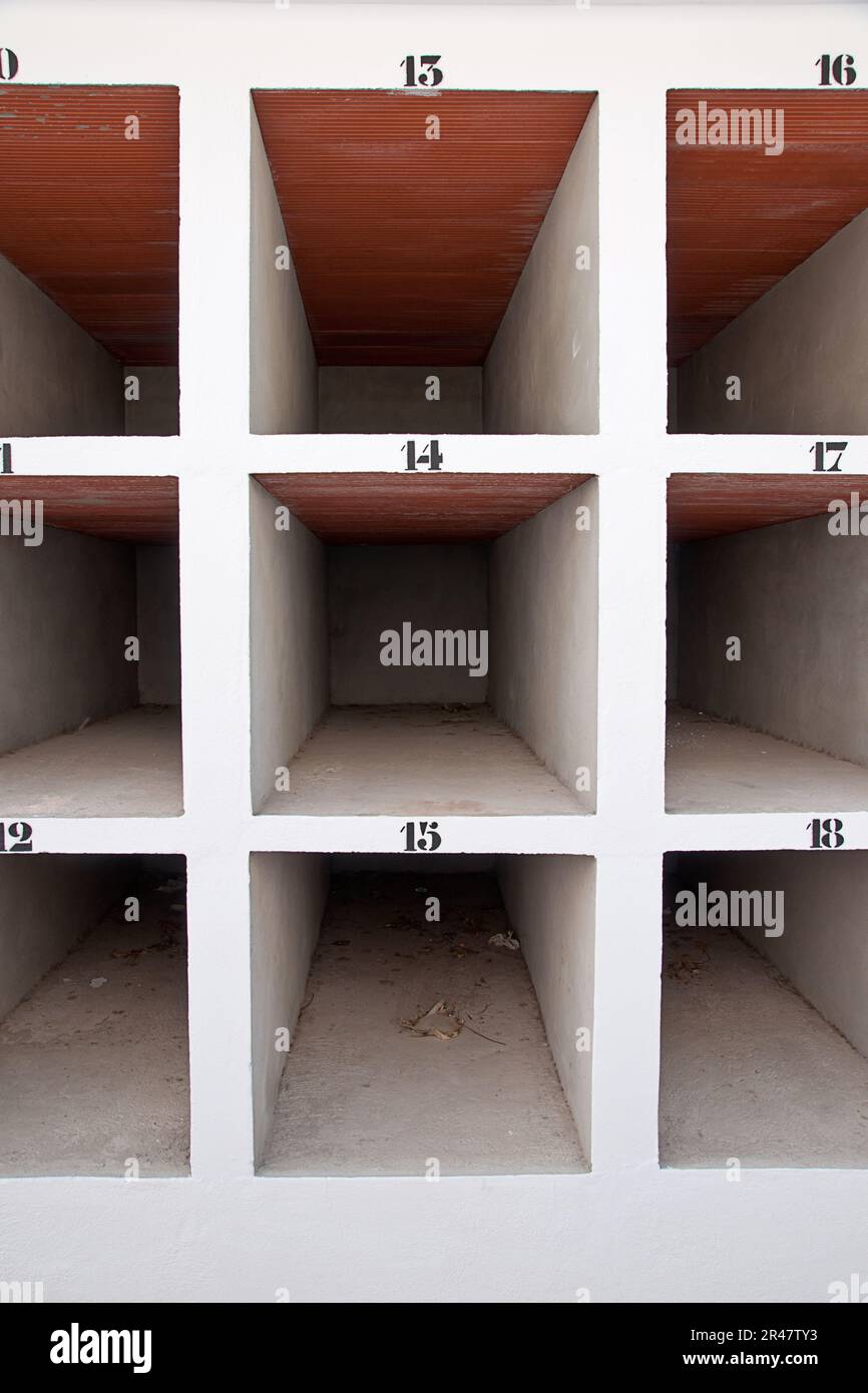 A vertical image of a shelving unit with multiple levels of numbered ...
