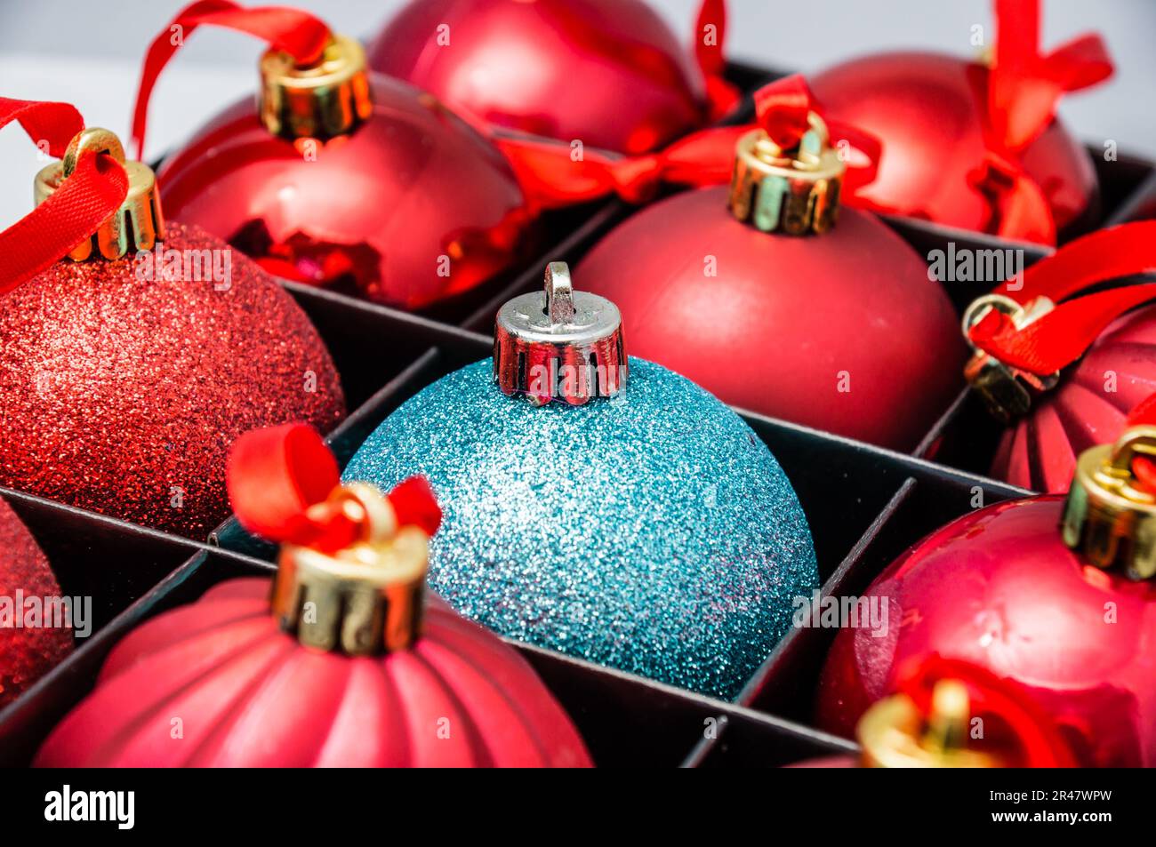 A festive arrangement of Christmas tree balls, stored in a black box ...
