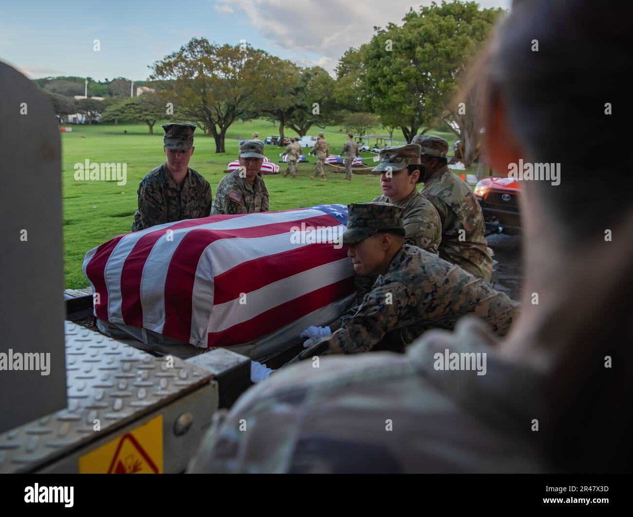 Defense POW/MIA Accounting Agency (DPAA) service members load a casket ...