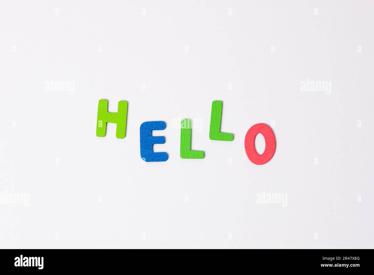 The word hello made of colored wooden letters on a light gray ...