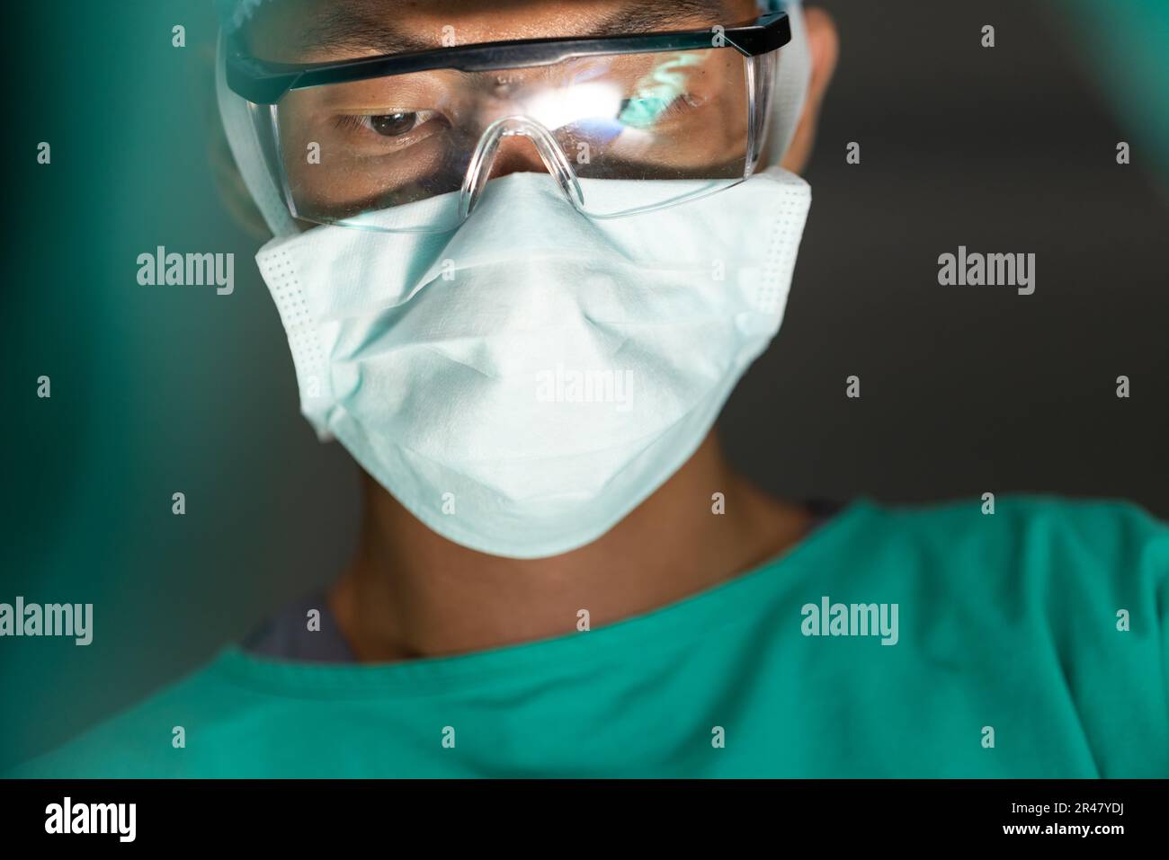 Asian male surgeon concentrating during surgery in operating theatre at ...