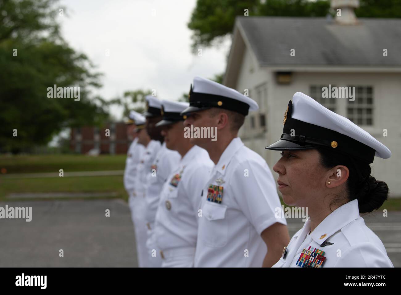 Chiefs and officers stand in formation during a dress whites uniform ...