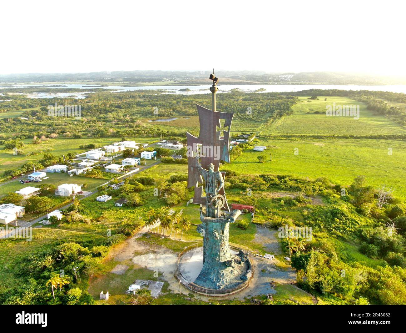 A scenic image of the Statue of Columbus, surrounded by lush green ...