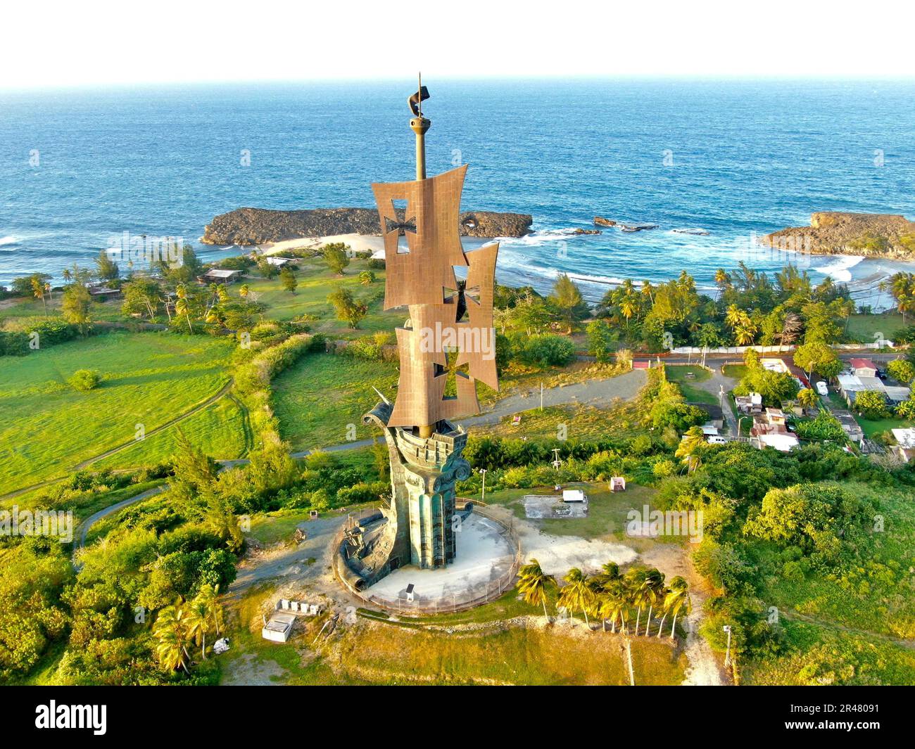 A scenic image of the Statue of Columbus, surrounded by lush green ...