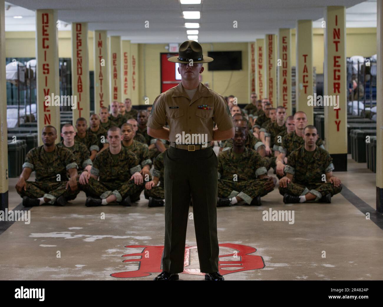 A drill instructor stands in front of recruits with Bravo Company, 1st ...