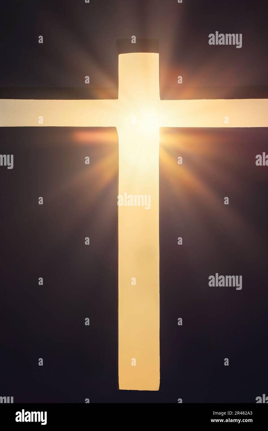 A Christian cross illuminated by a sunbeam on a black background Stock ...