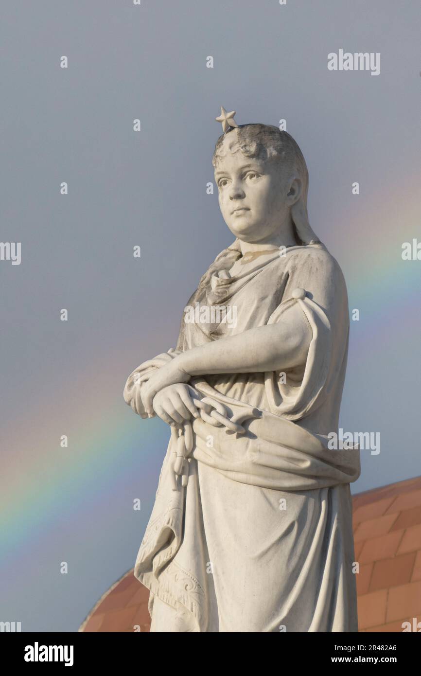 An intricately detailed bronze statue, set against a colorful backdrop ...