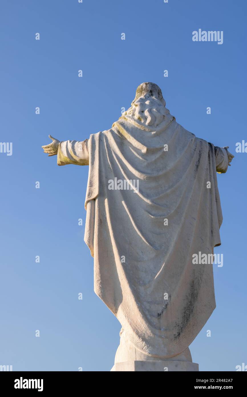 A majestic bronze statue atop a pedestal with its arms outstretched ...