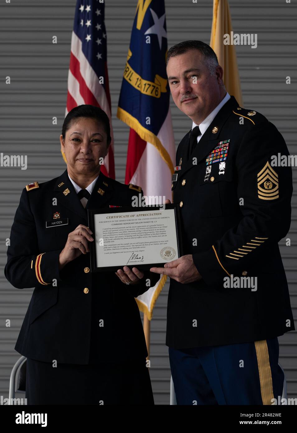 Command Sgt. Maj. Randy Ly, right, completes his last official duty for ...