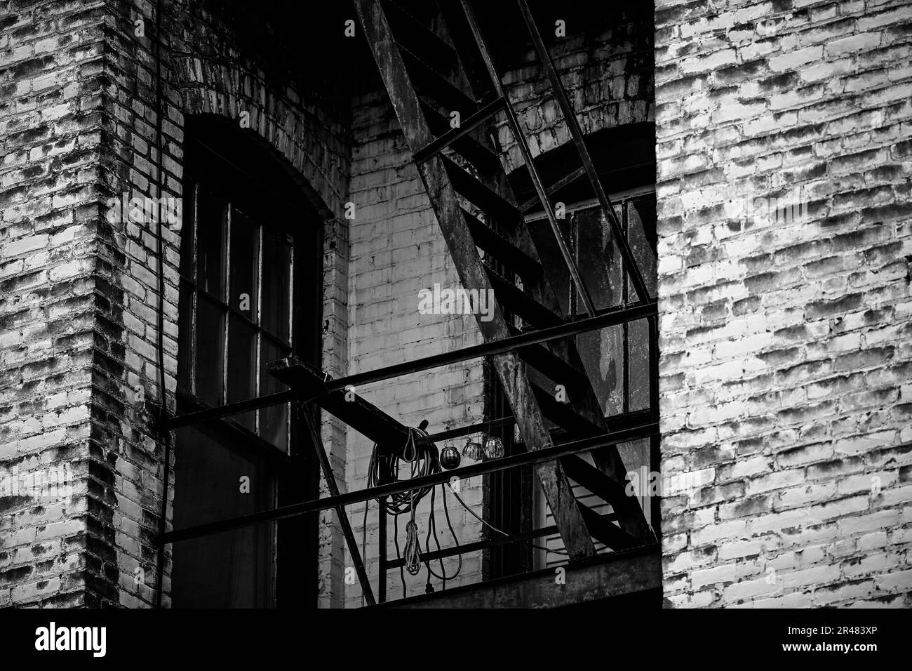 An old brick building exterior in grayscale Stock Photo - Alamy