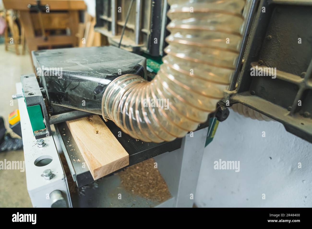 Wooden plank moving under sawdust extractor to make the environment ...
