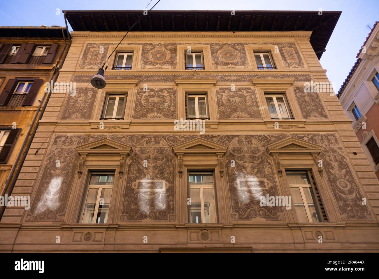 Residential building with exterior frescoes on a busy street in Rome ...