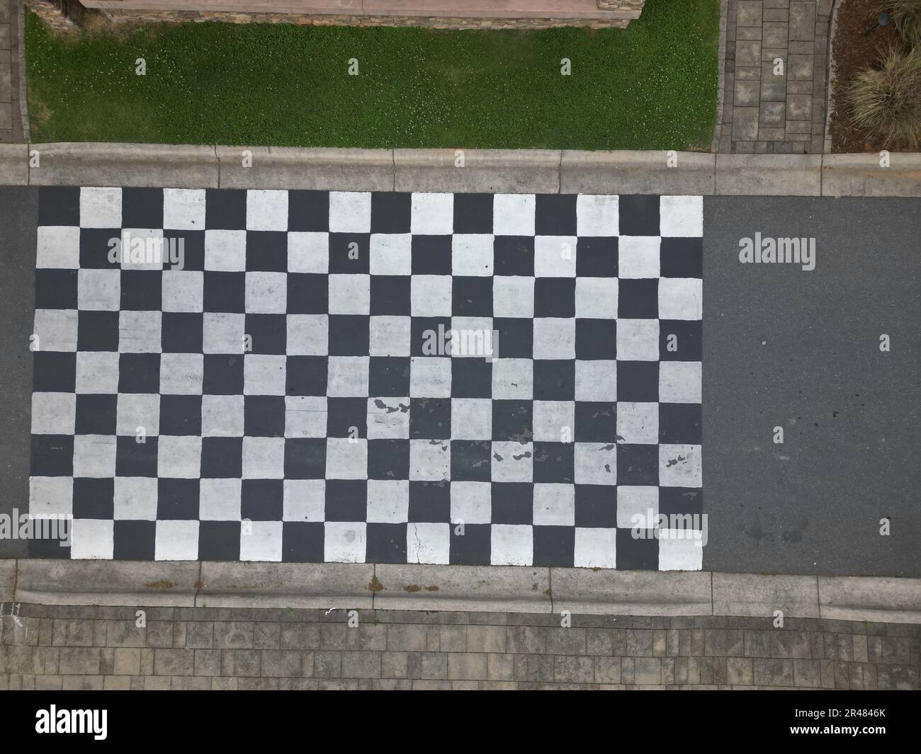 An aerial top view of checkerboard patterns on a raceline Stock Photo ...
