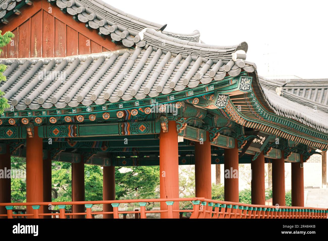 An Asian-style pavilion with multiple, brightly-colored orange pillars ...