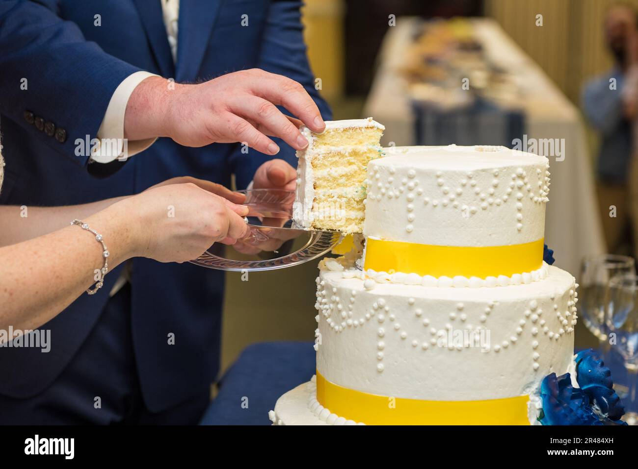 A newlywed couple celebrating their union by cutting into a delicious ...