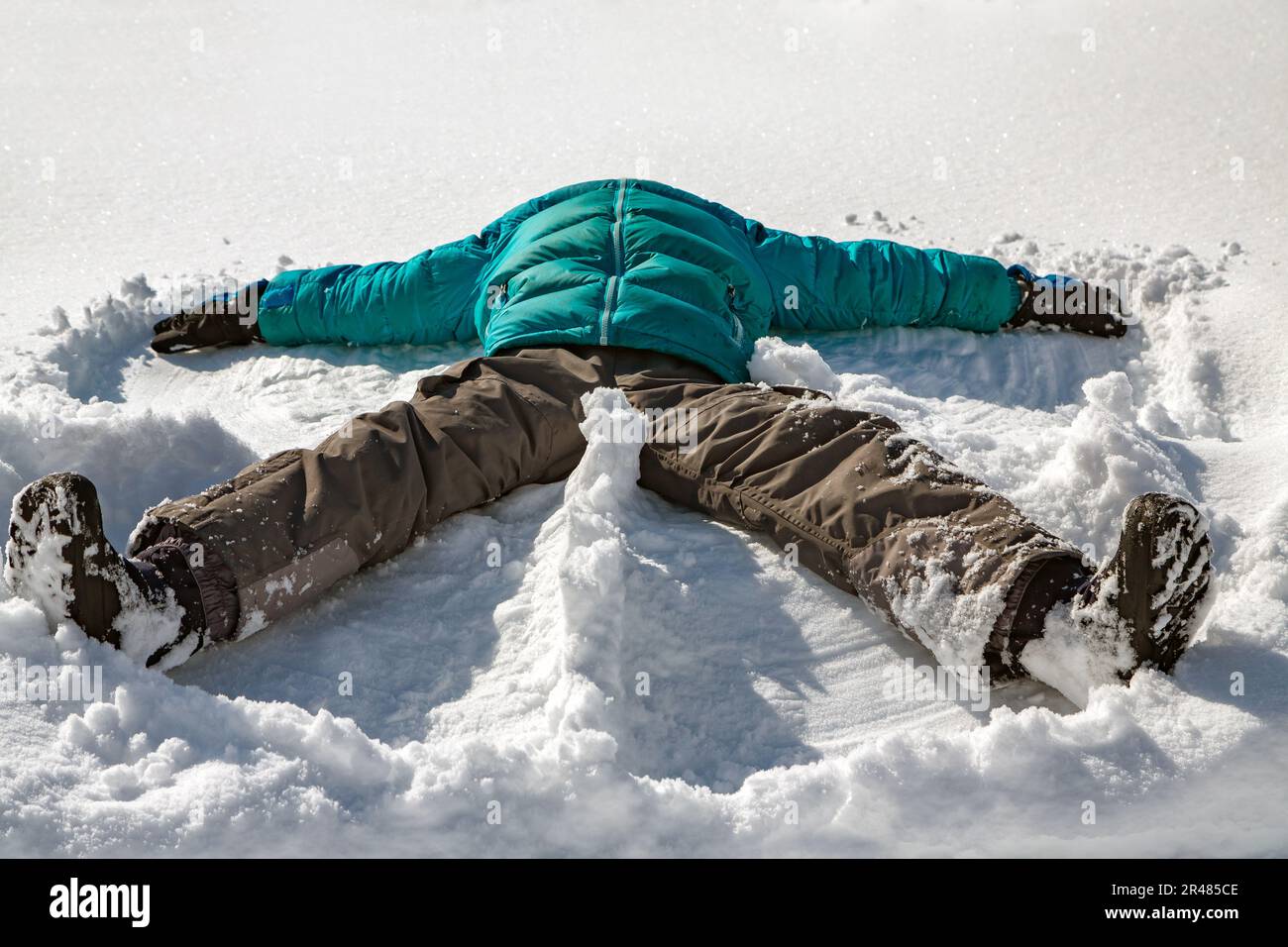 boy makes the snow angel Stock Photo - Alamy