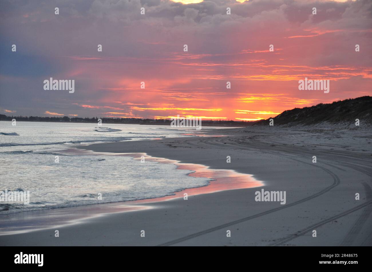 Picturesque beach scene featuring a stunning sunset in the background ...