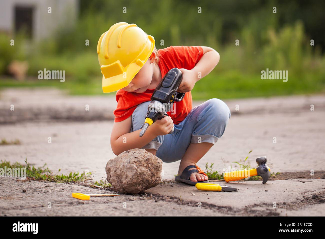 Little boy with toy tools outdoor. Involve child in work Stock Photo ...