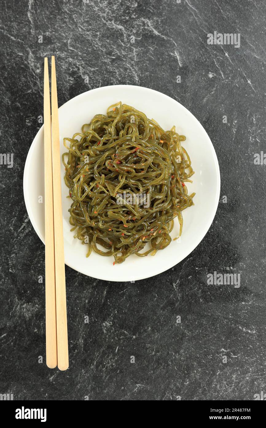 Spicy Green Shirataki Noodle with Chili Flakes. Top View on White Plate ...