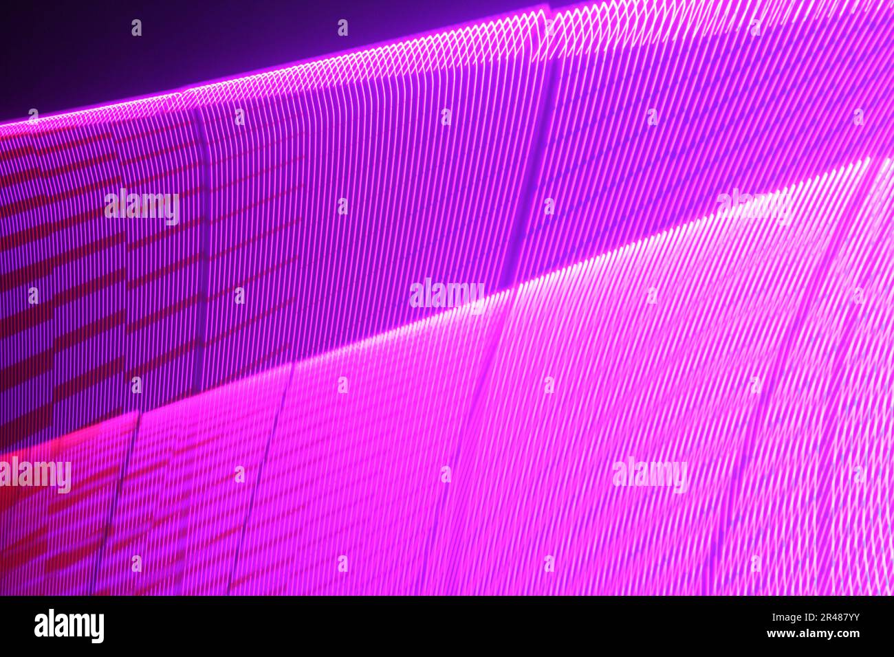 A large display featuring a pattern of pink lights radiating outward ...