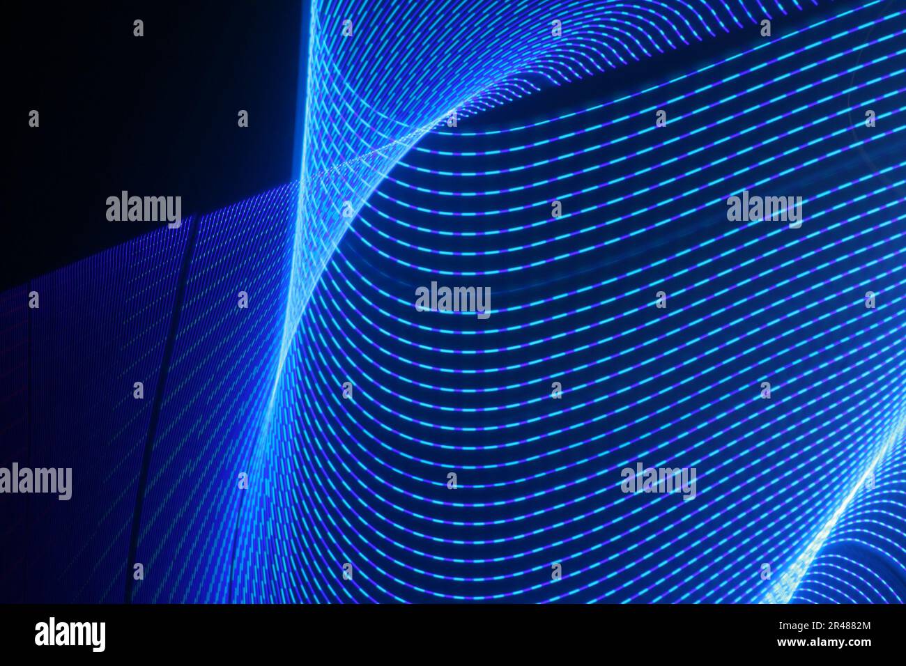 A large display featuring a pattern of blue lights radiating outward ...