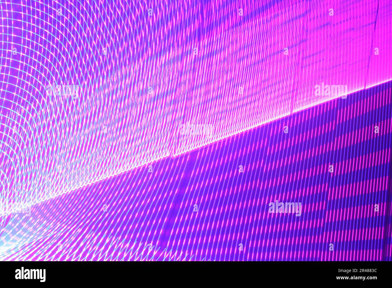 A large display featuring a pattern of pink and blue lights radiating ...