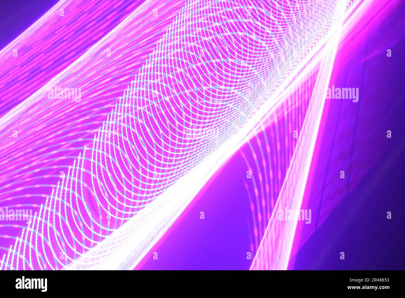 A large display featuring a pattern of pink lights radiating outward ...