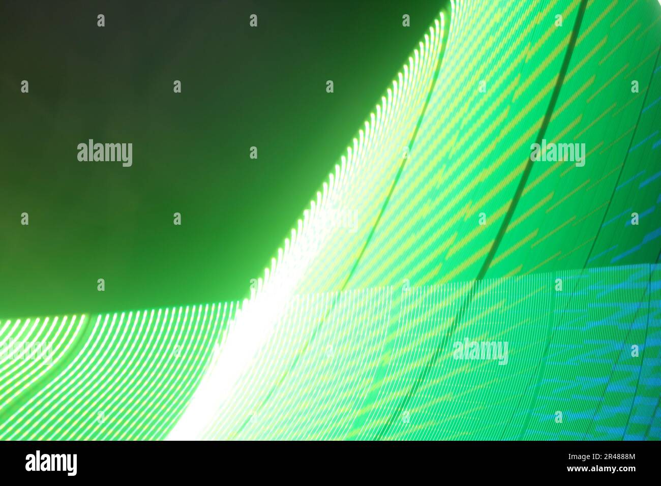 A large display featuring a pattern of green lights radiating outward ...