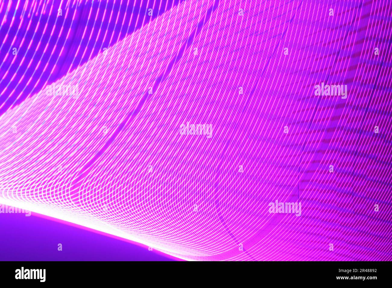 A large display featuring a pattern of pink lights radiating outward ...