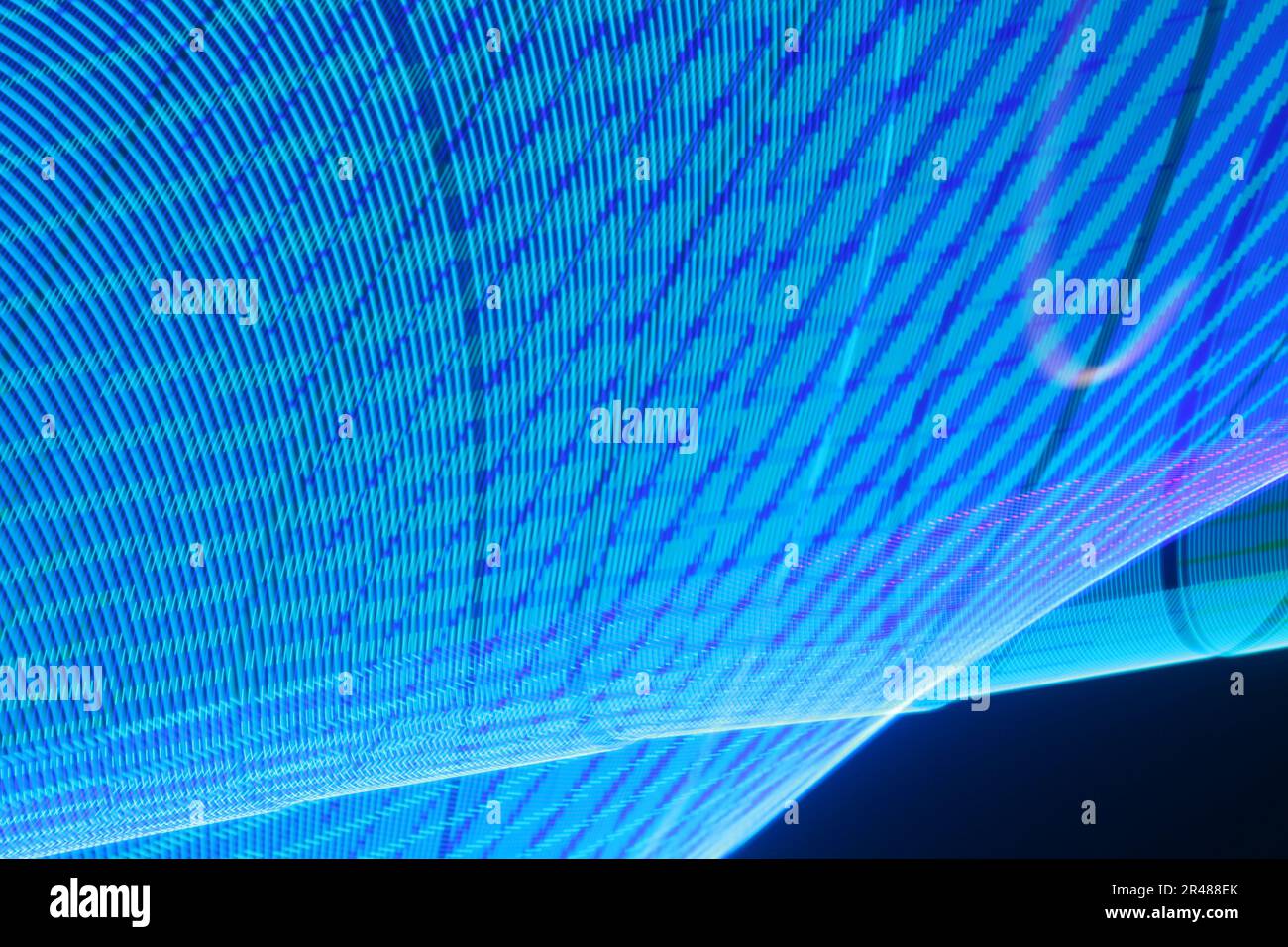 A large display featuring a pattern of blue lights radiating outward ...