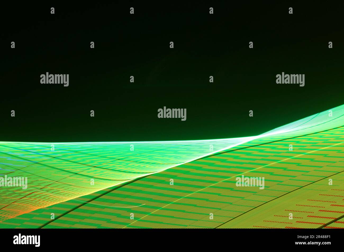 A large display featuring a pattern of green lights radiating outward ...