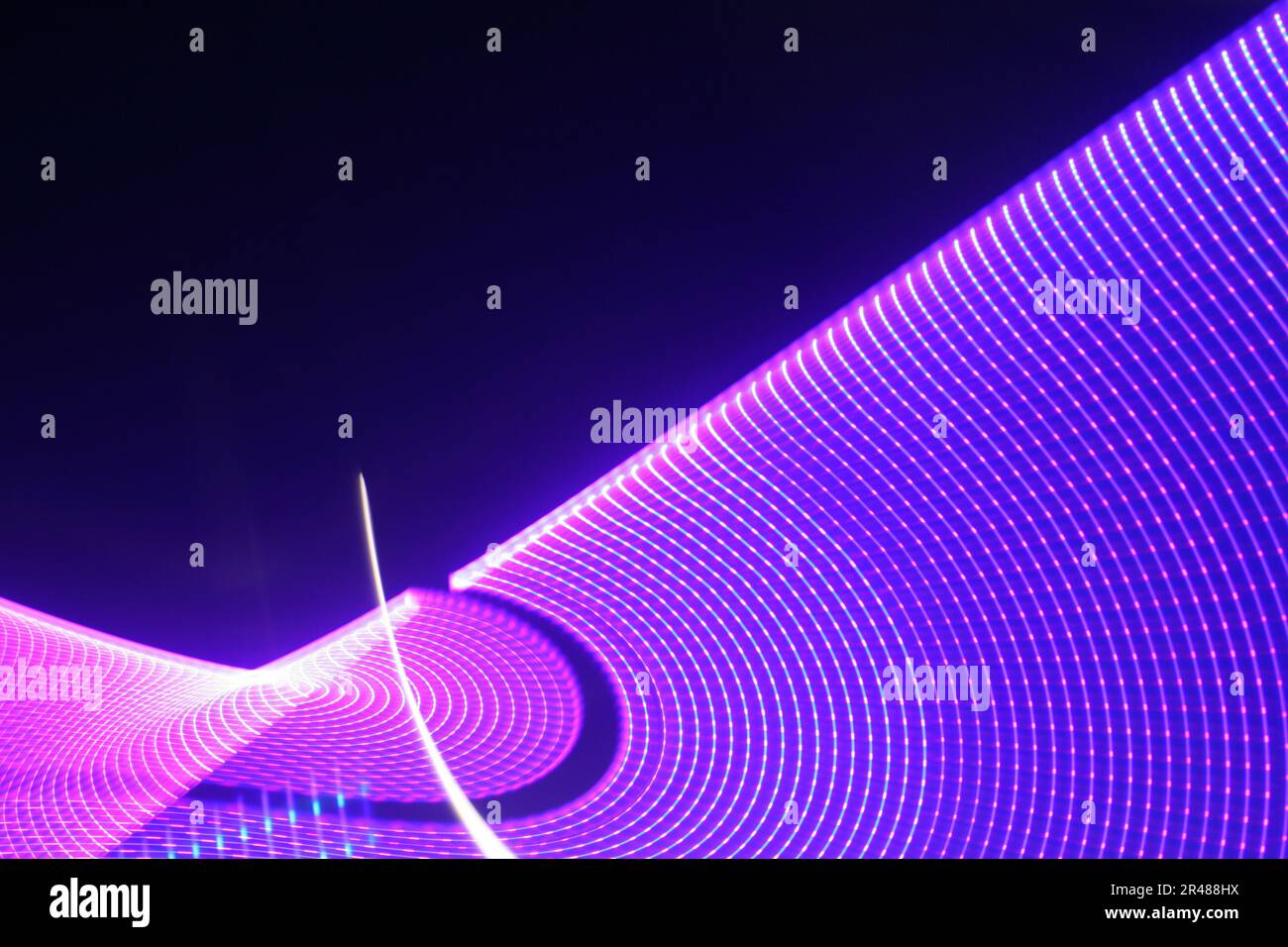 A large display featuring a pattern of purple and blue lights radiating ...