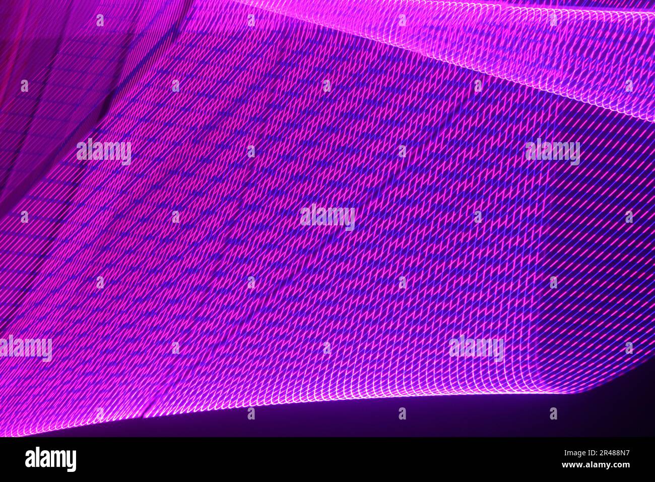 A large display featuring a pattern of pink lights radiating outward ...