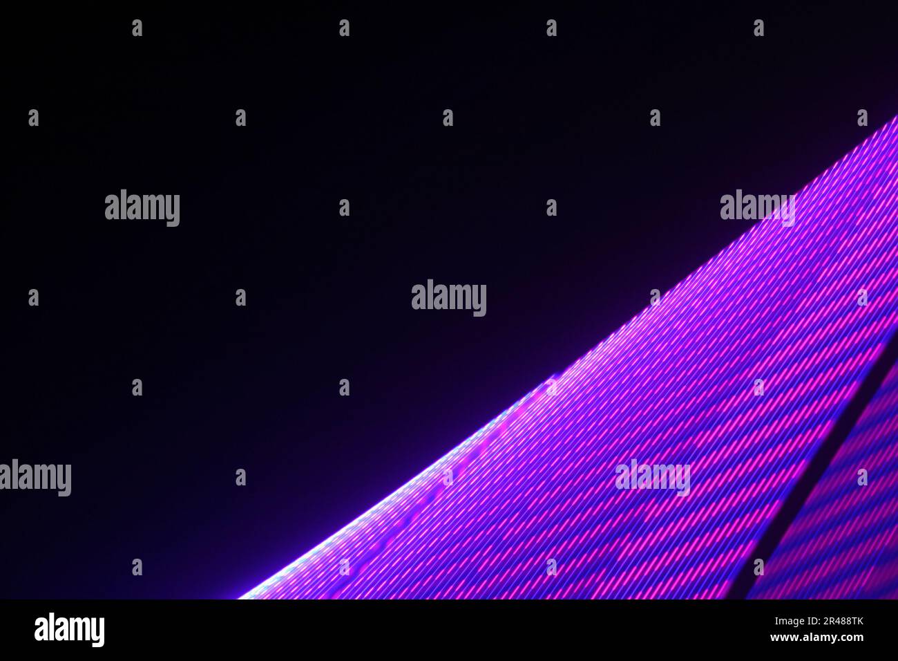 A large display featuring a pattern of blue and pink lights radiating ...