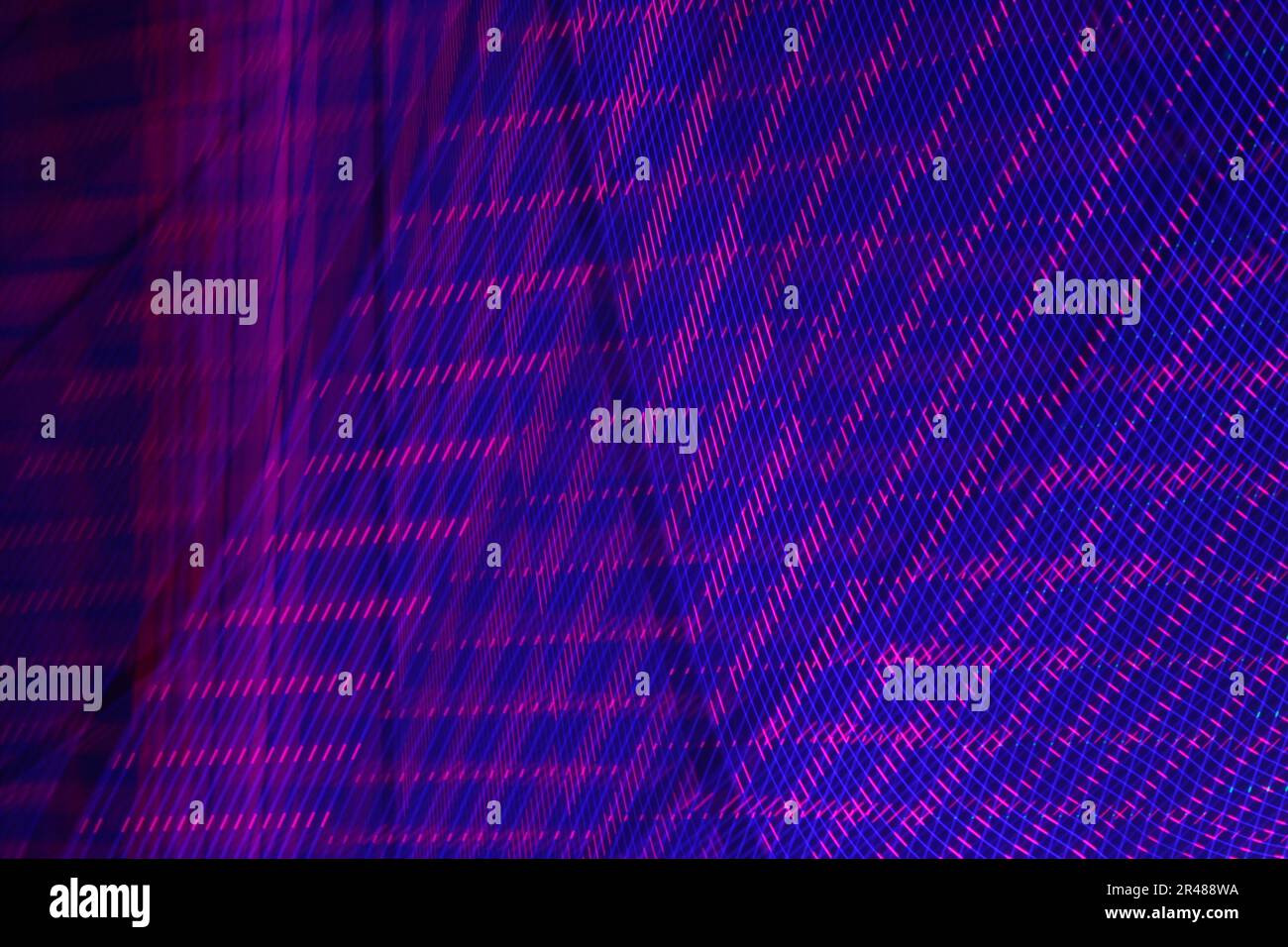 A large display featuring a pattern of blue and pink lights radiating ...