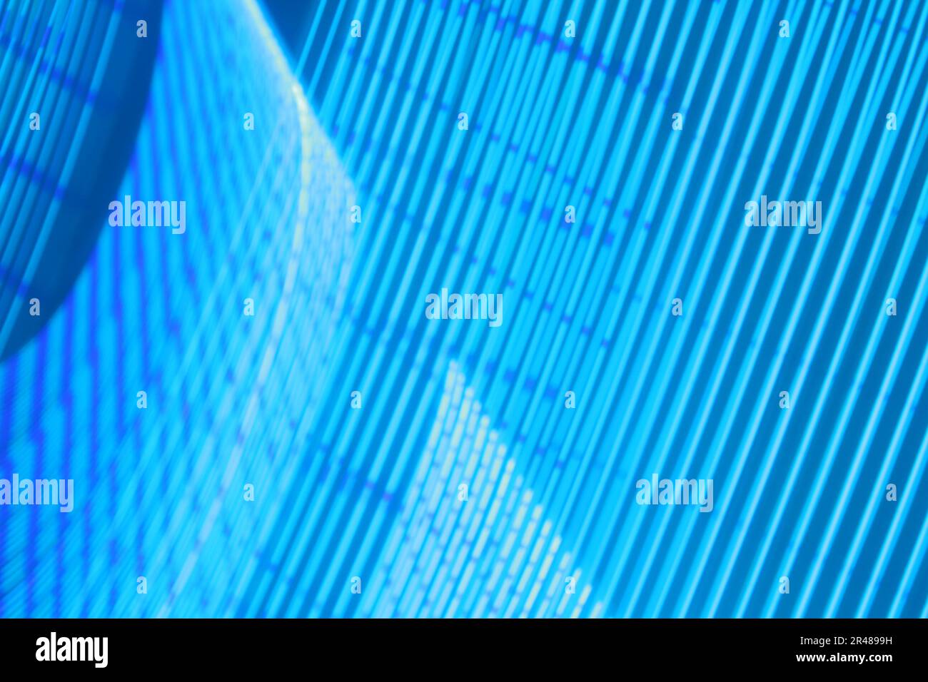 A large display featuring a pattern of blue lights radiating outward ...