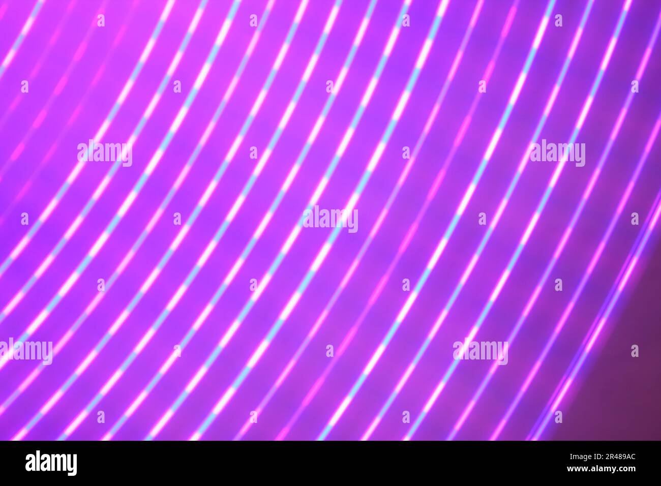 A large display featuring a pattern of pink lights radiating outward ...