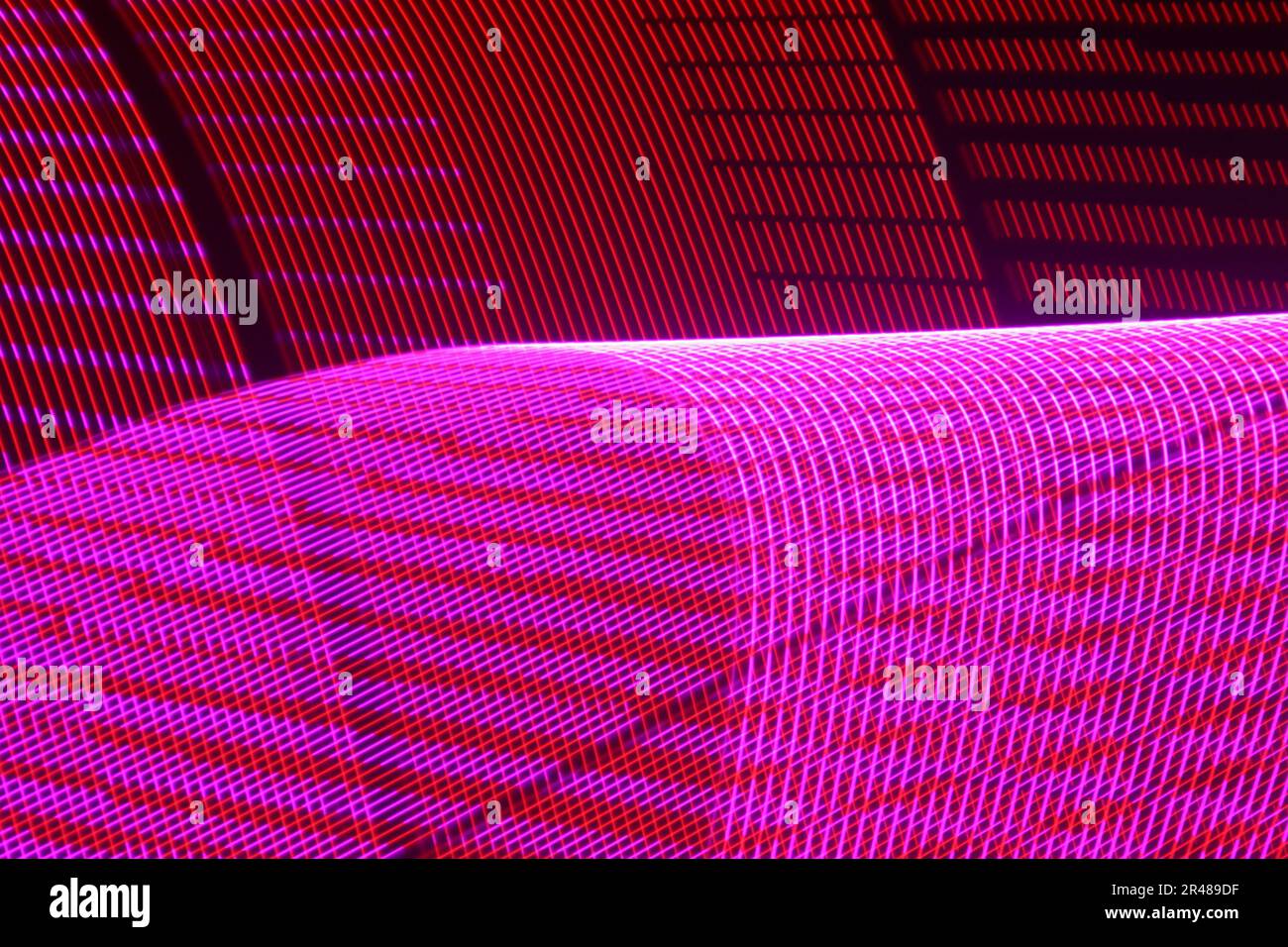A large display featuring a pattern of pink lights radiating outward ...