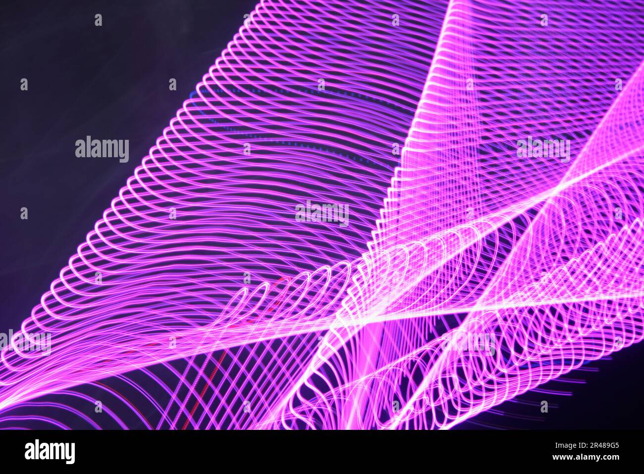 A large display featuring a pattern of pink lights radiating outward ...