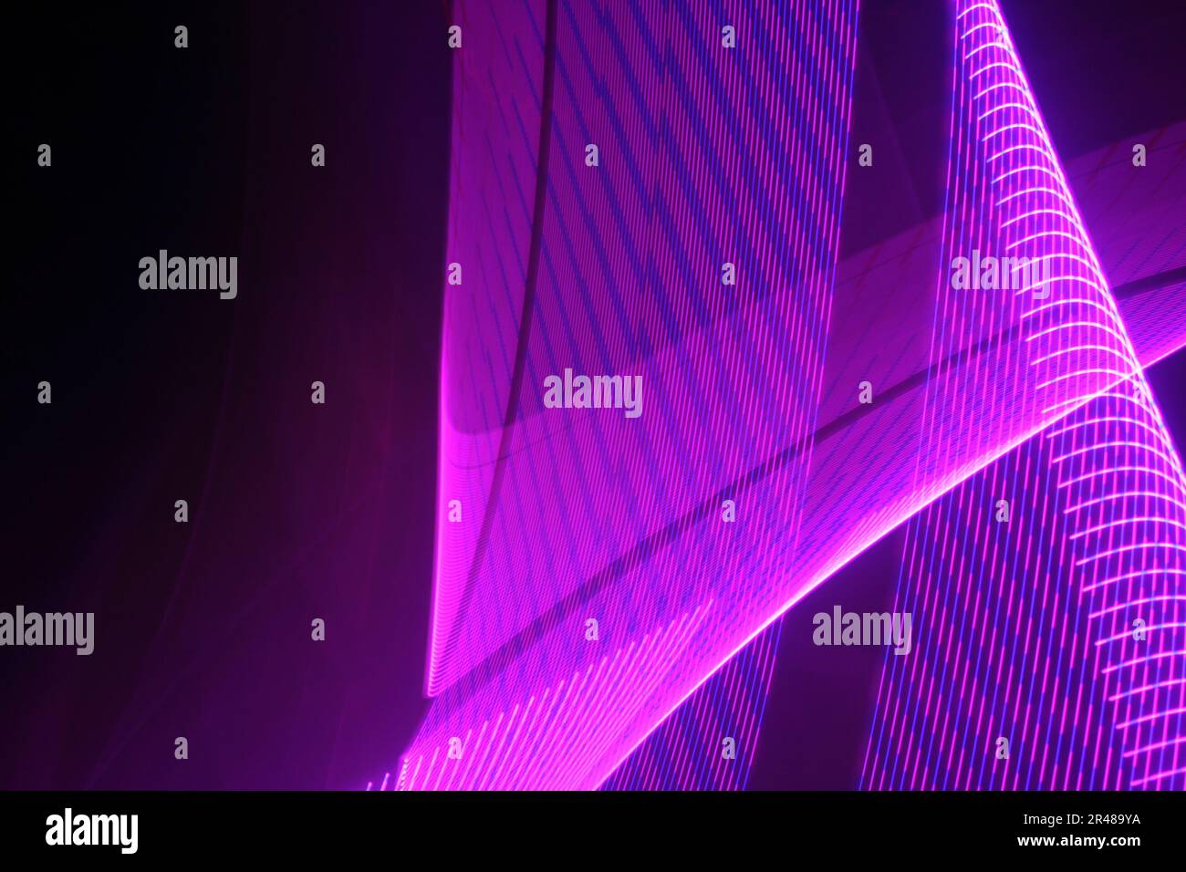 A large display featuring a pattern of pink lights radiating outward ...